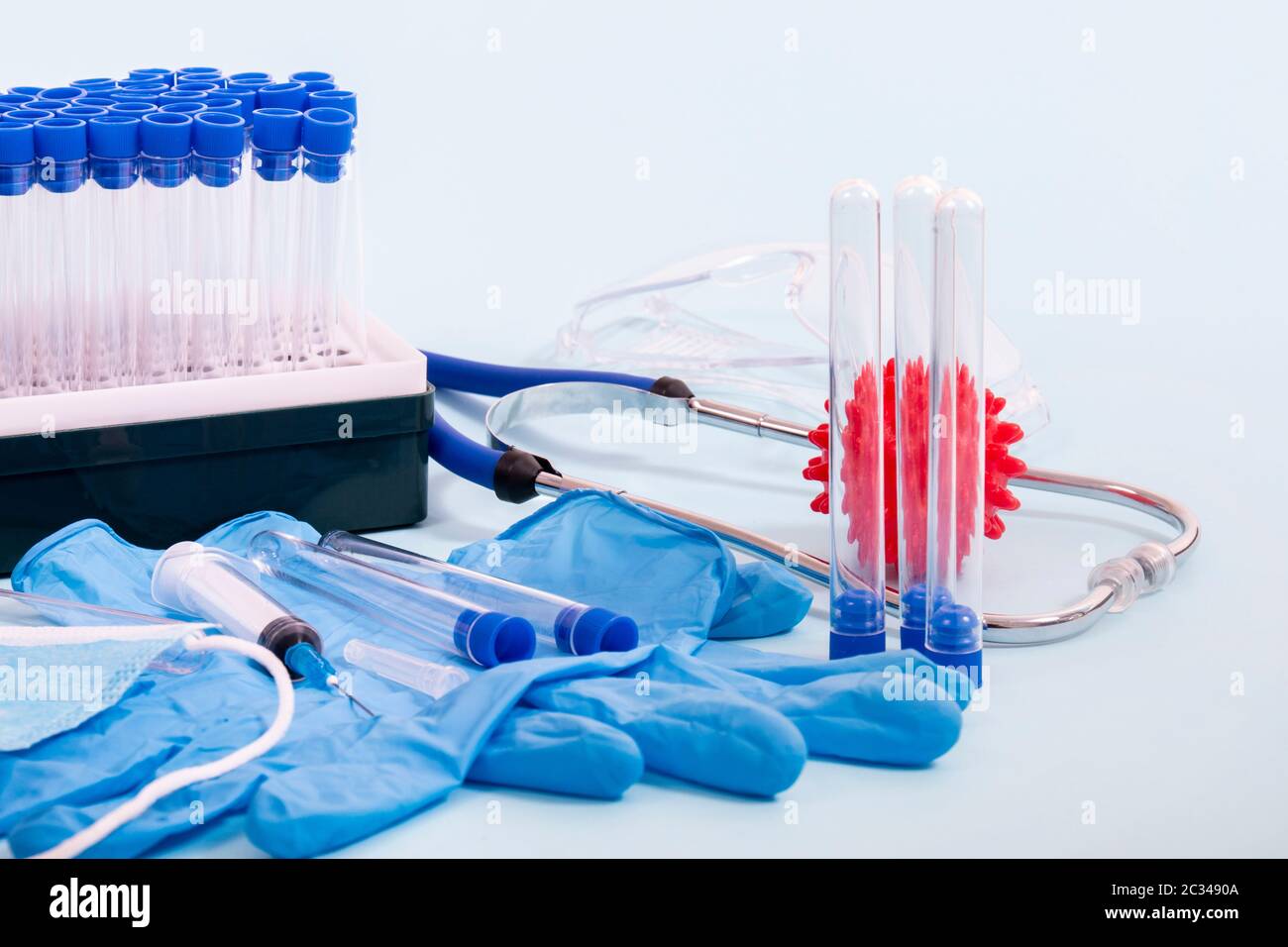 Several laboratory objects including protective mask, gloves, vial rack ...