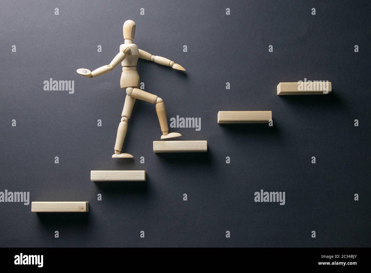 Wooden man walk up the career stairs. Ladder made with wooden bricks ...
