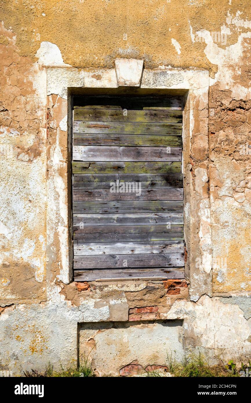 old stone building with damage, part of an old structure with boarded ...