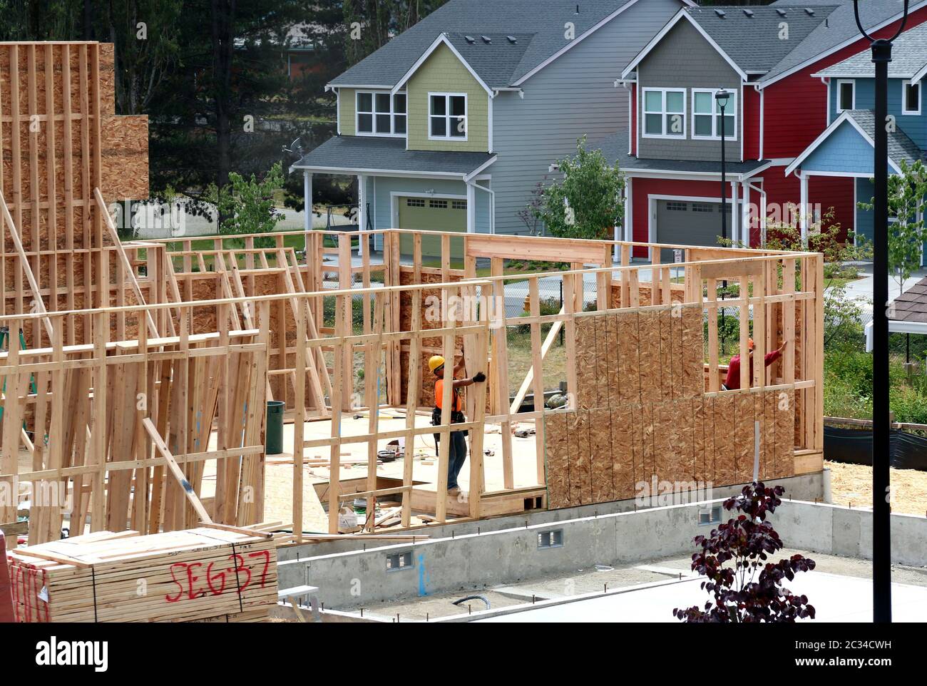 residential house under construction by male worker Stock Photo - Alamy