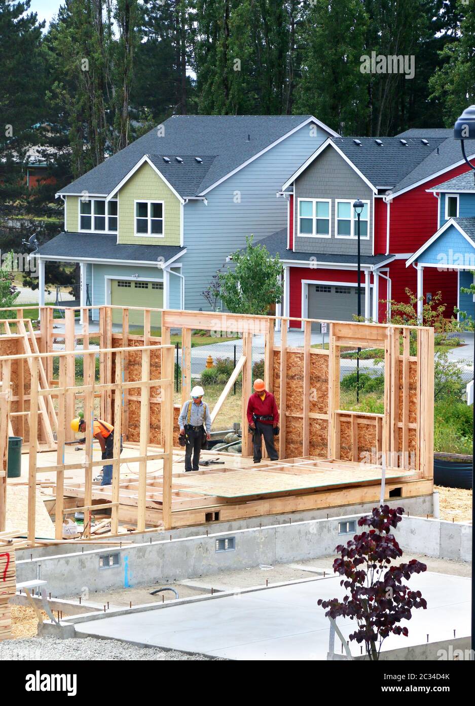 residential house under construction by male worker Stock Photo - Alamy