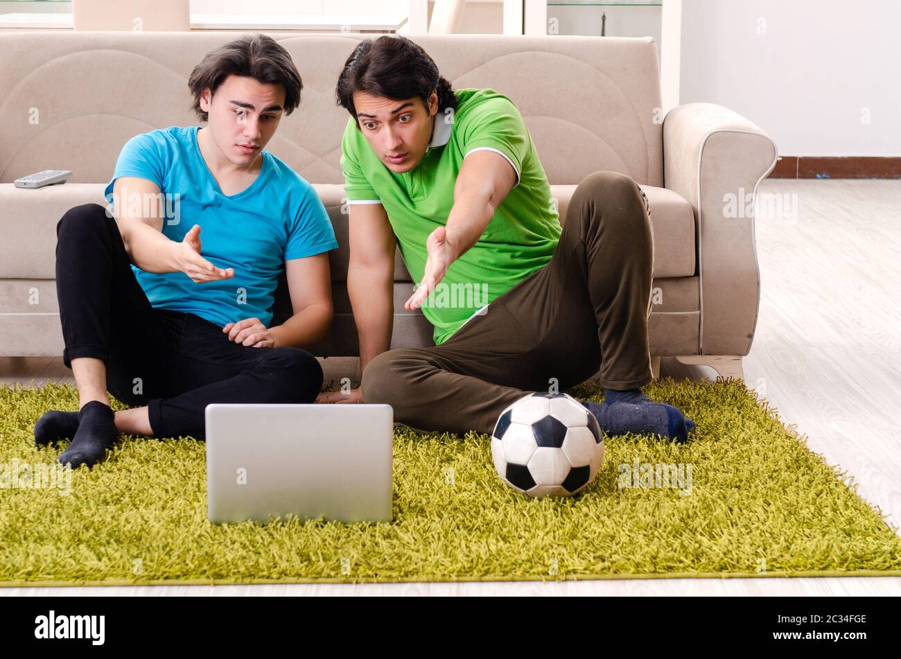 Friends watching football at home Stock Photo - Alamy