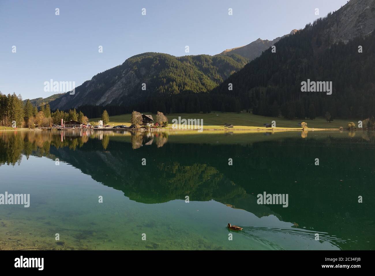 The Tyrolean mountains in Austria are reflected in the clear lake Stock ...