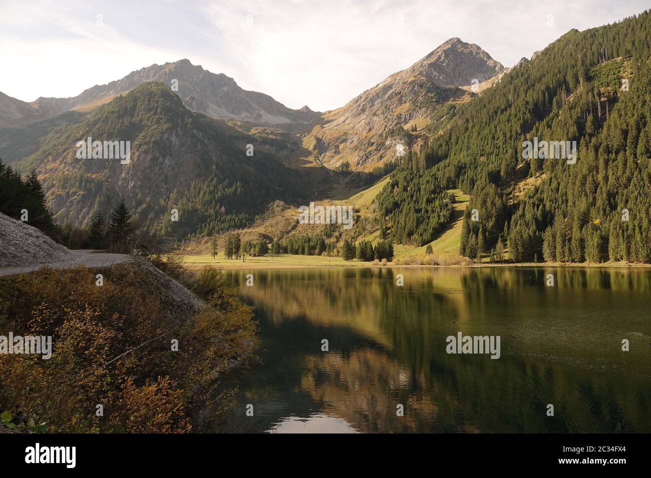 The Tyrolean mountains in Austria are reflected in the clear lake Stock ...