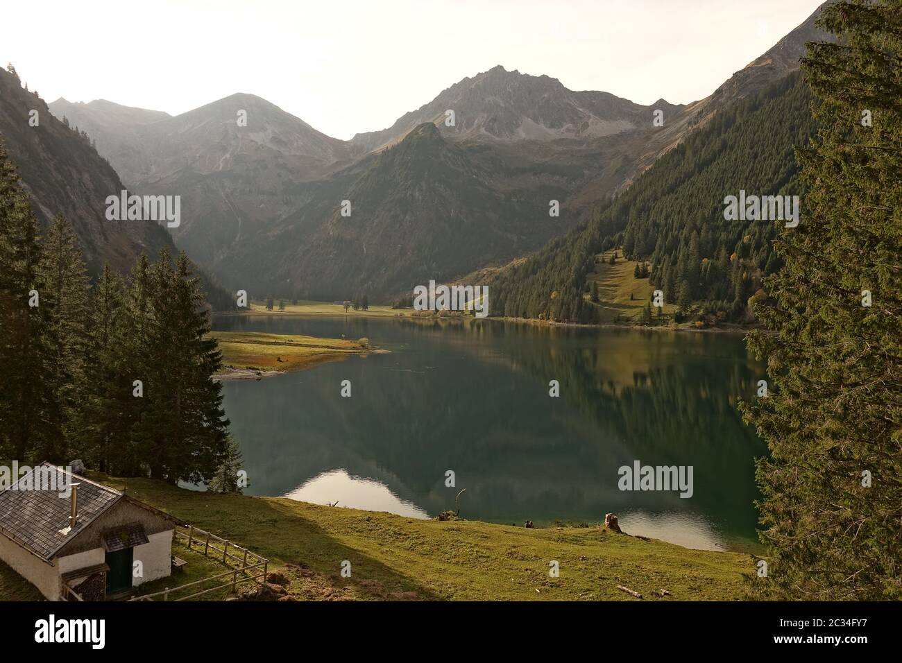 The Tyrolean mountains in Austria are reflected in the clear lake Stock ...
