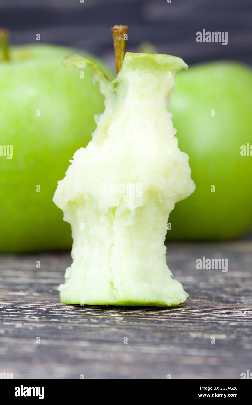 the core of a green ripe and juicy Apple, lies on a cutting Board made ...