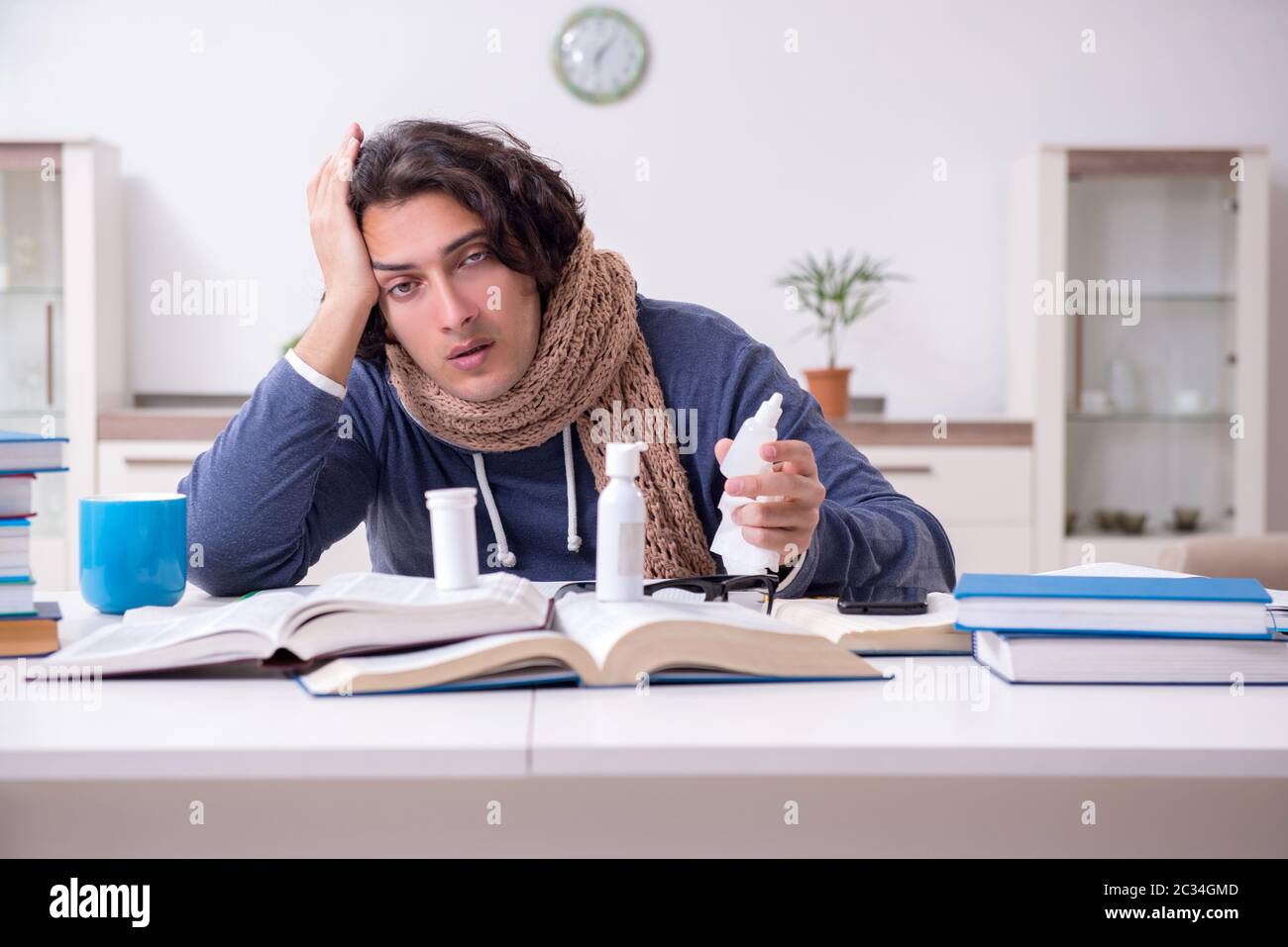 Sick male student suffering at home Stock Photo - Alamy
