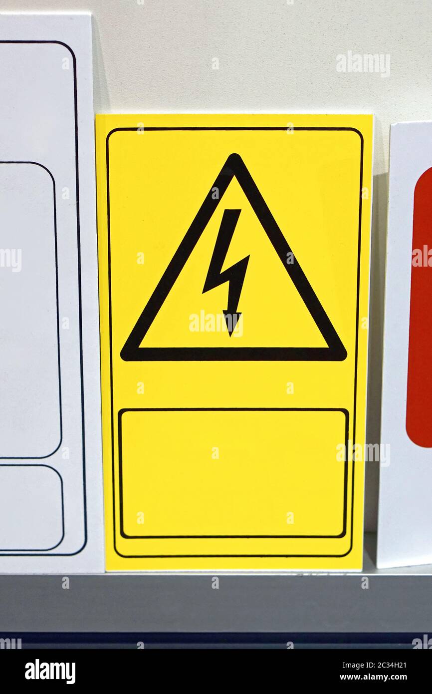 Yellow electric shock warning sign Stock Photo - Alamy