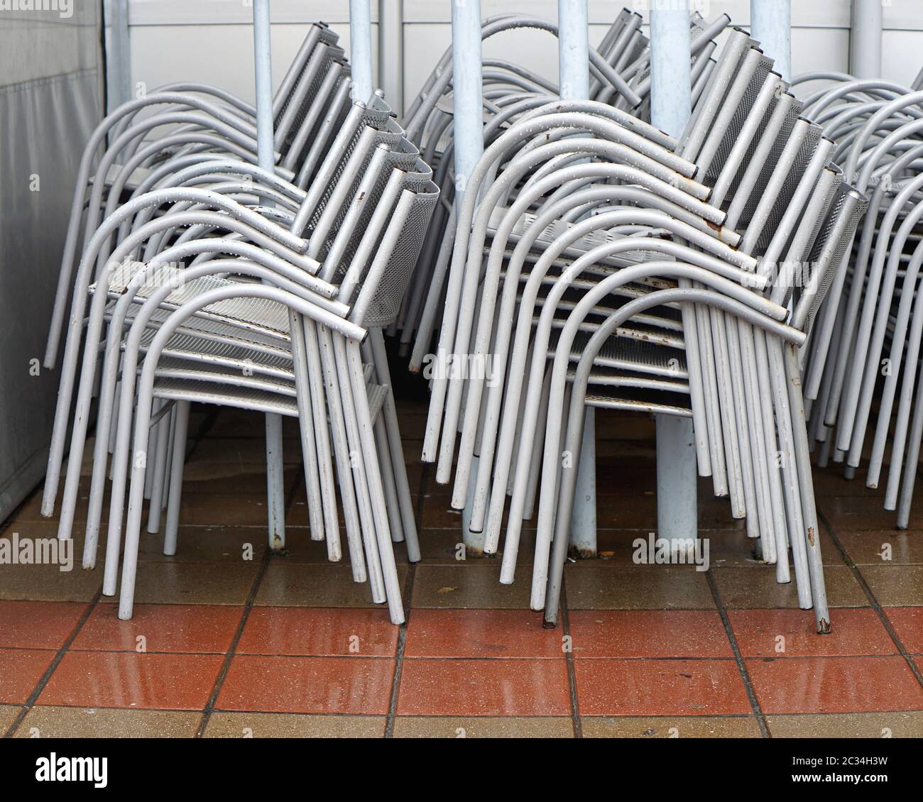 Packed stack of metal chairs Stock Photo - Alamy