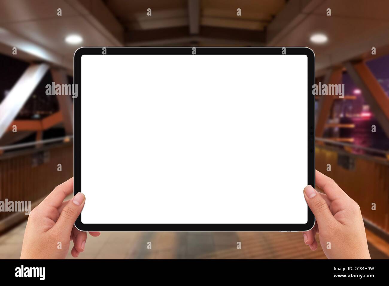 The two hands holding white screen mockup tablet computer on Hong Kong ...