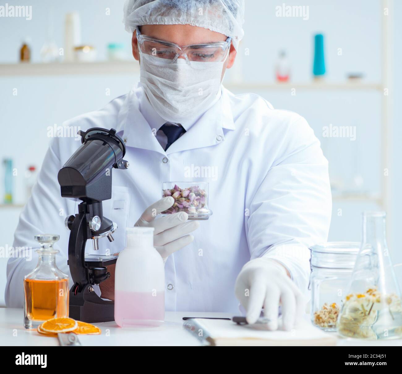 Chemist mixing perfumes in the lab Stock Photo - Alamy