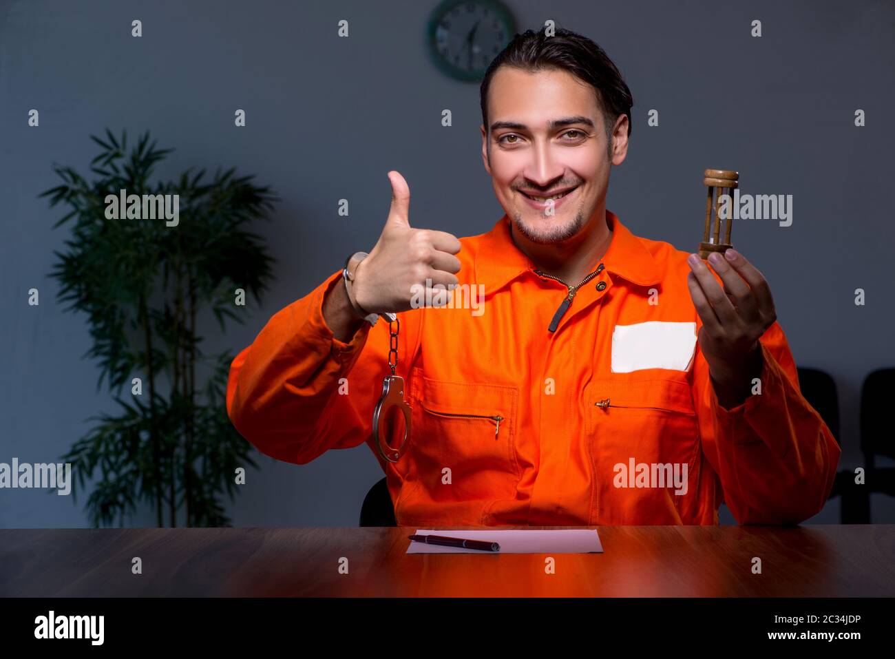 Young convict man sitting in dark room Stock Photo - Alamy