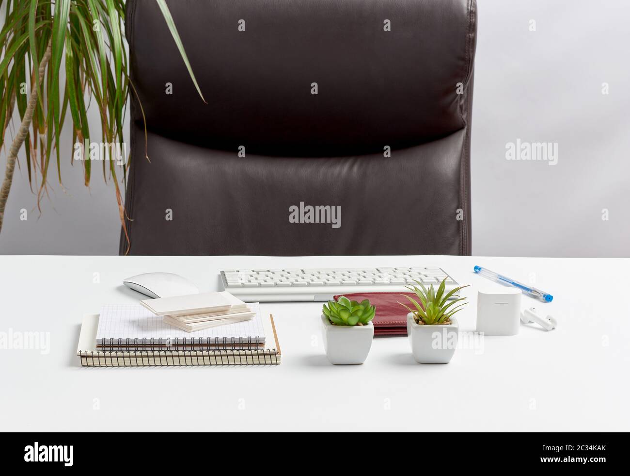 White table with stationery, wireless keyboard, mouse, workplace of a ...