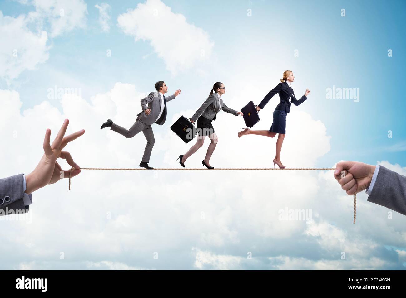 Business people walking on tight rope Stock Photo - Alamy
