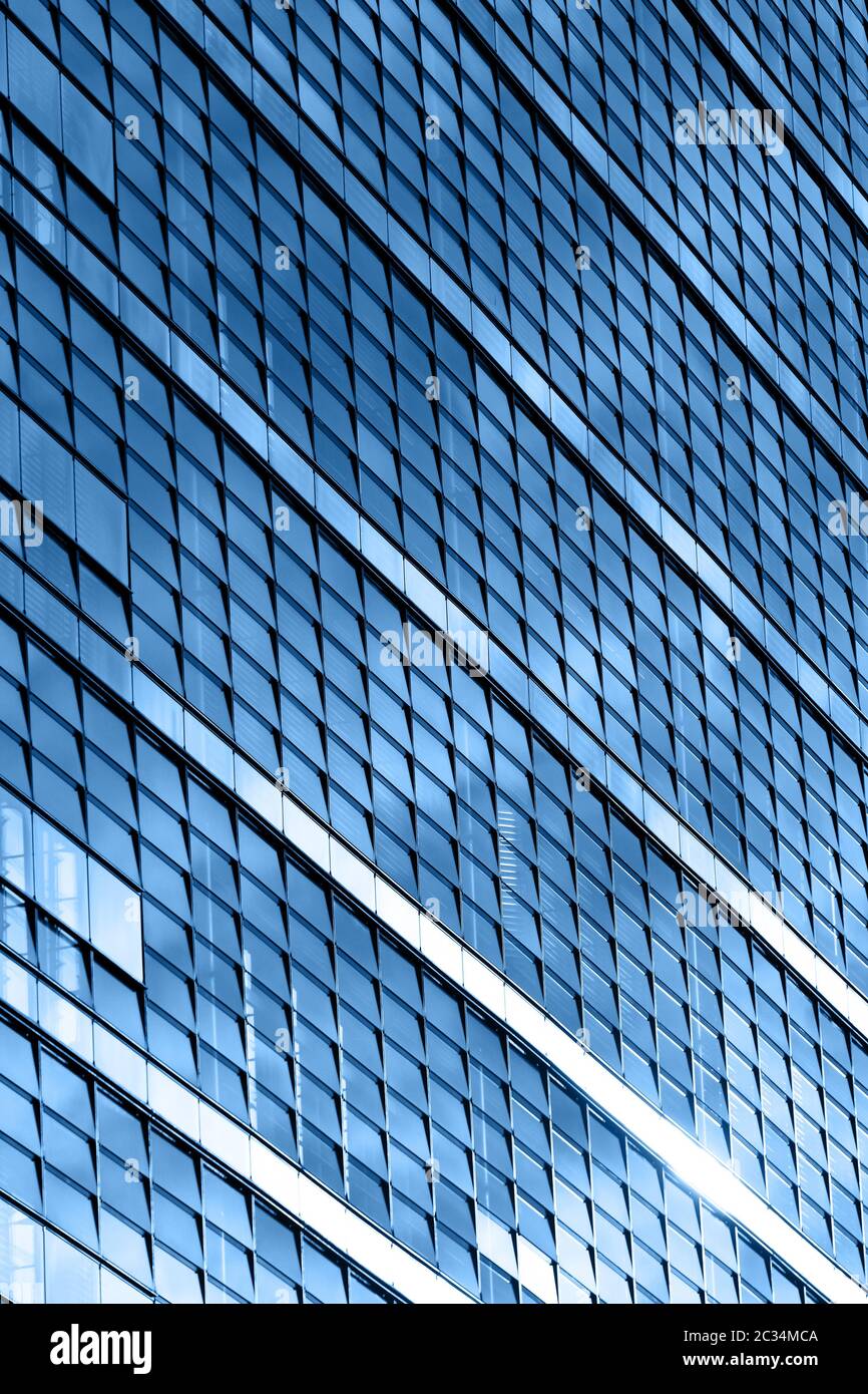 Blue glass windows of modern business office building, diagonal ...