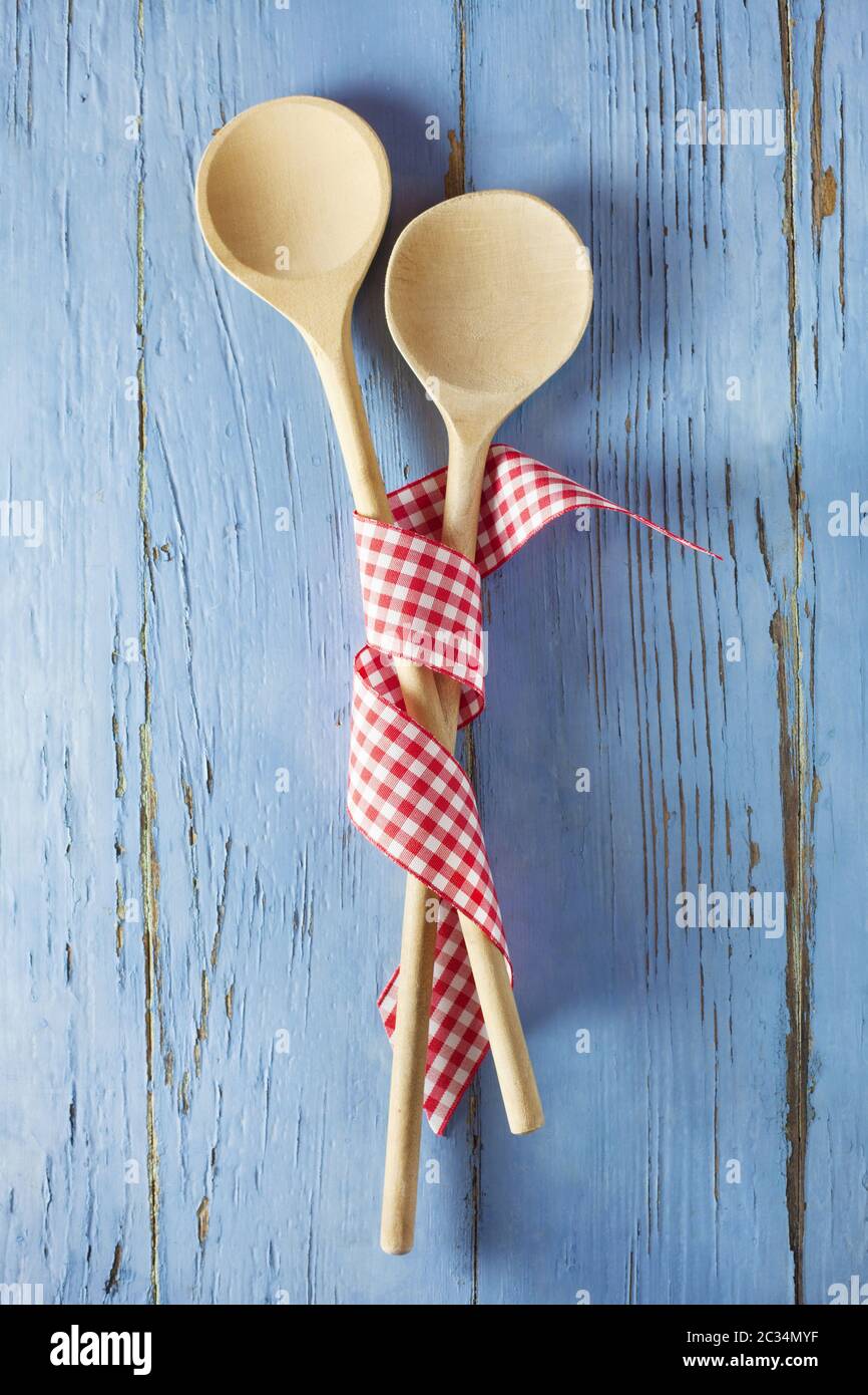 Wooden Spoons On A Blue Background Stock Photo - Alamy