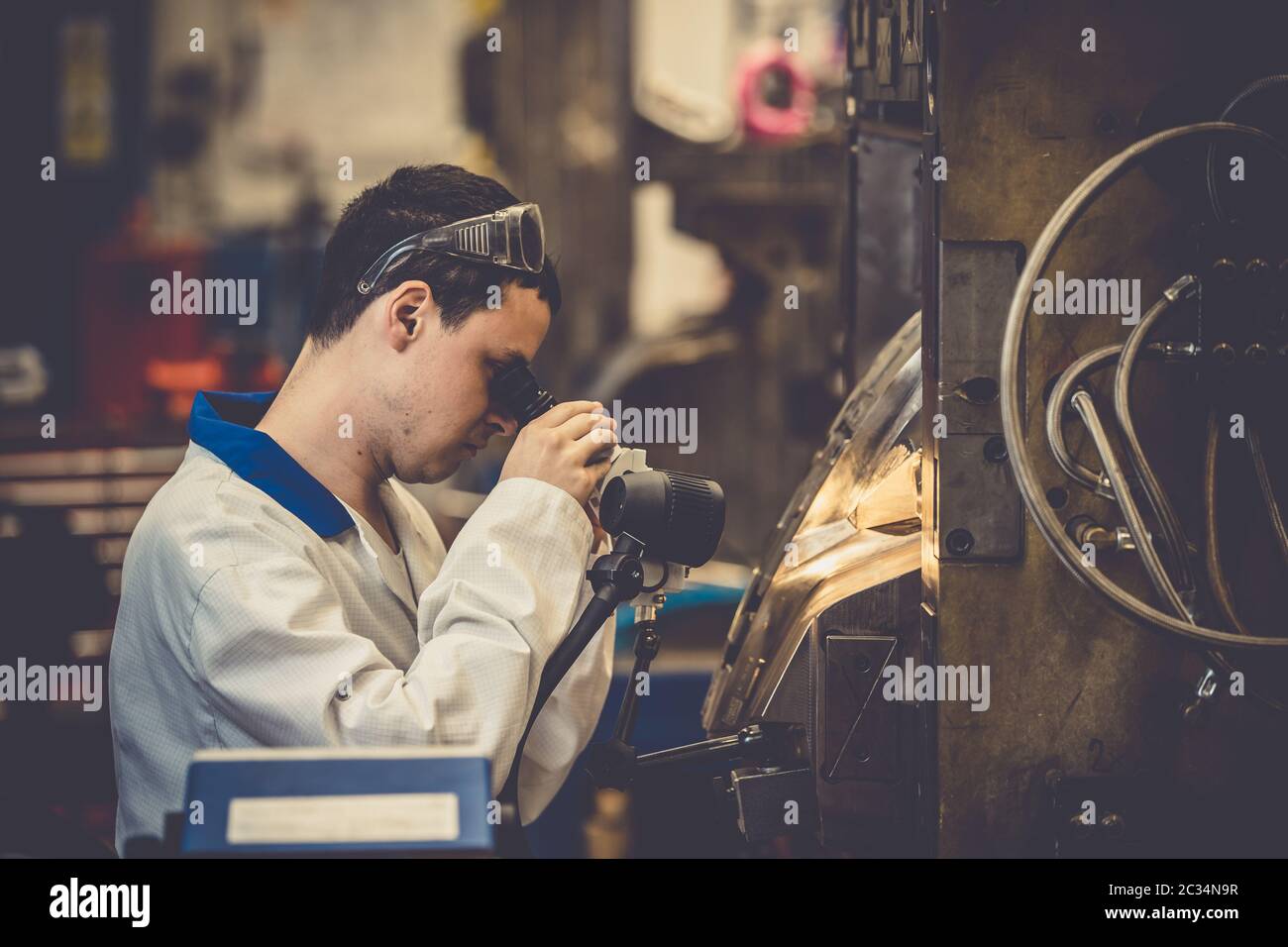 Inspection of the polished surface on a metal mold using a microscope ...