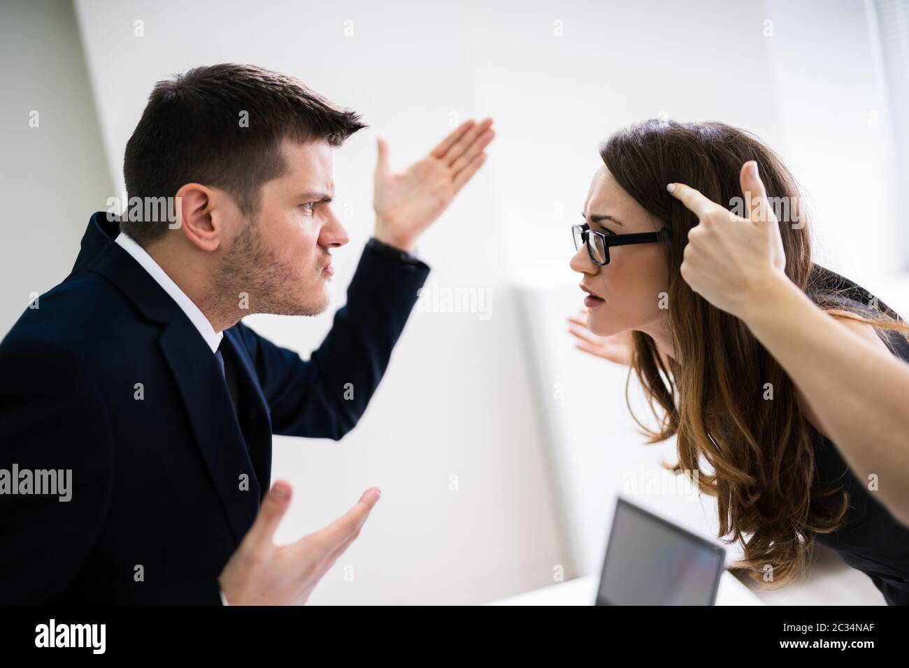 Side View Of Business People Quarreling At Desk In Office Stock Photo ...