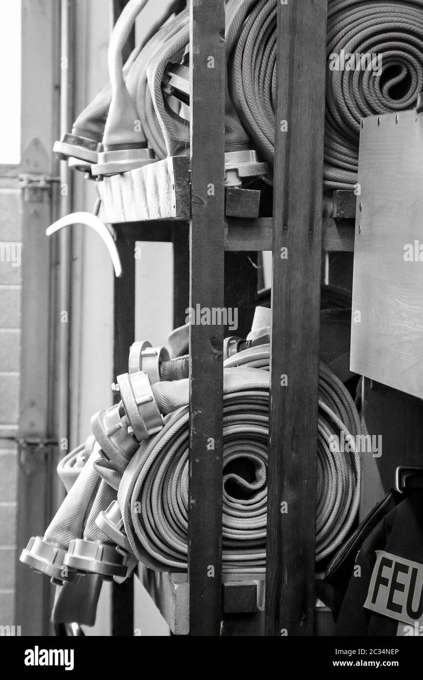 Fire department hoses stacked on a shelf for use Stock Photo - Alamy