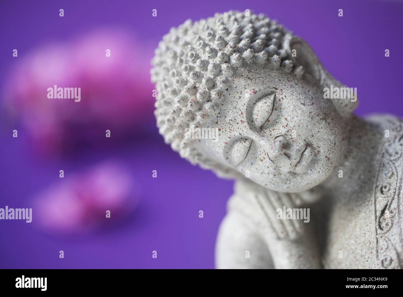 Buddha Figure On A Purple Background Stock Photo - Alamy