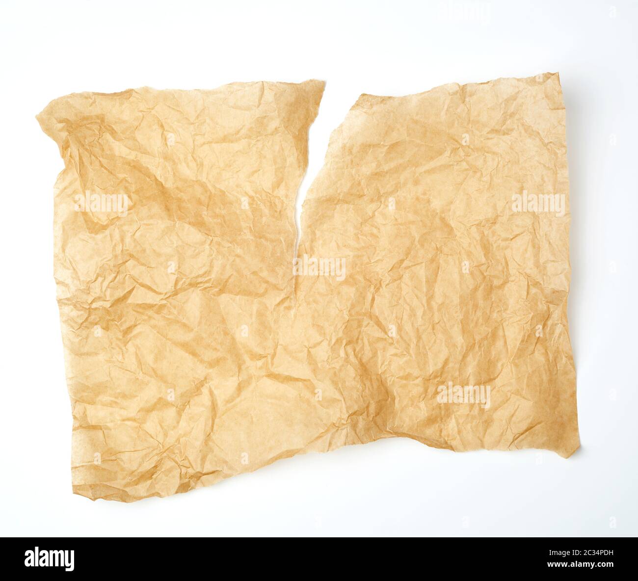torn piece of brown piece of parchment paper on white background Stock ...