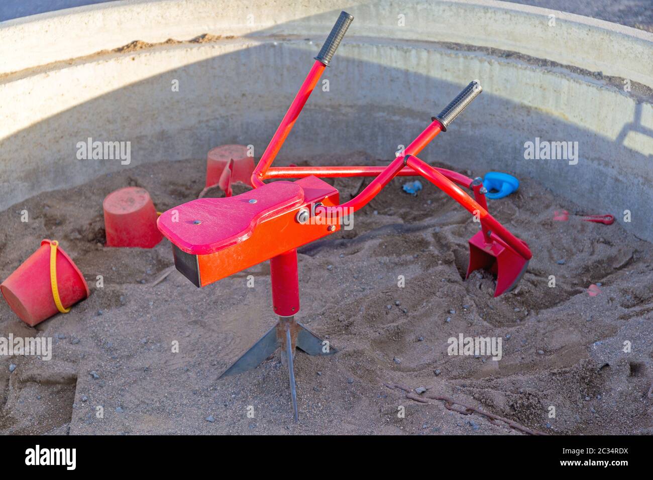 Red Metal Digger Children Toy in Sandpit Stock Photo - Alamy