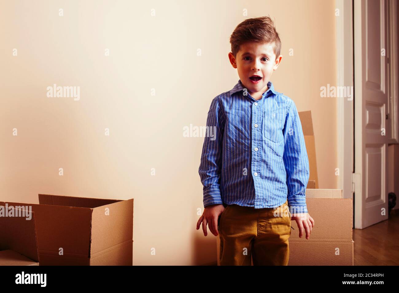 little cute boy in empty room, move to new house. home alone among ...