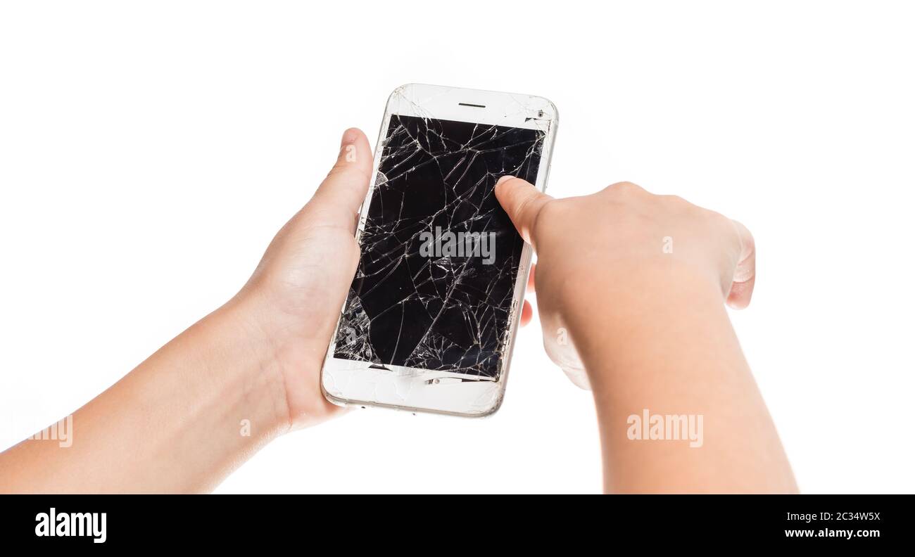 angry little girl holding a smartphone with broken screen in studio ...