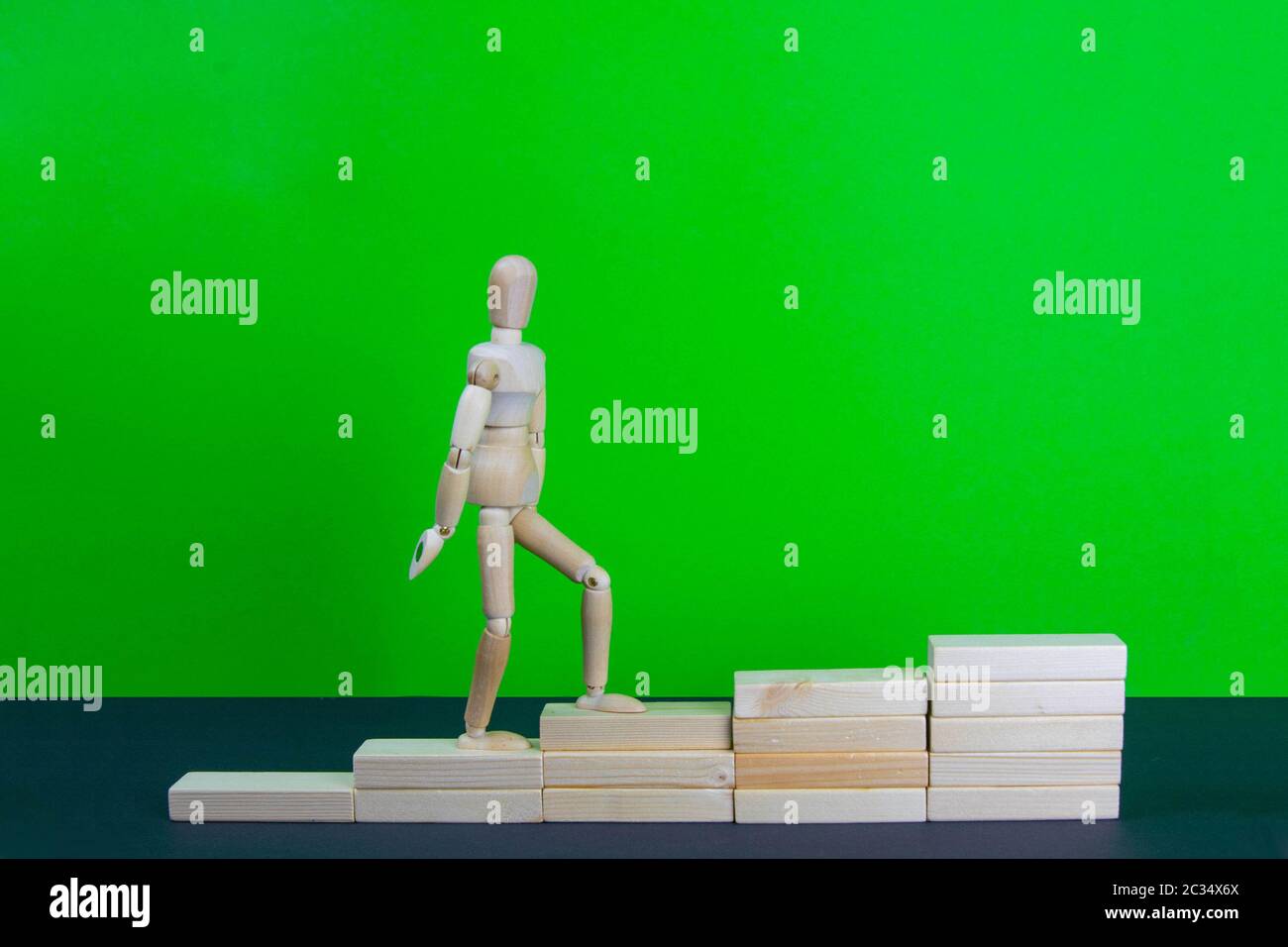 Wooden man walk up the career stairs. Ladder made with wooden bricks ...