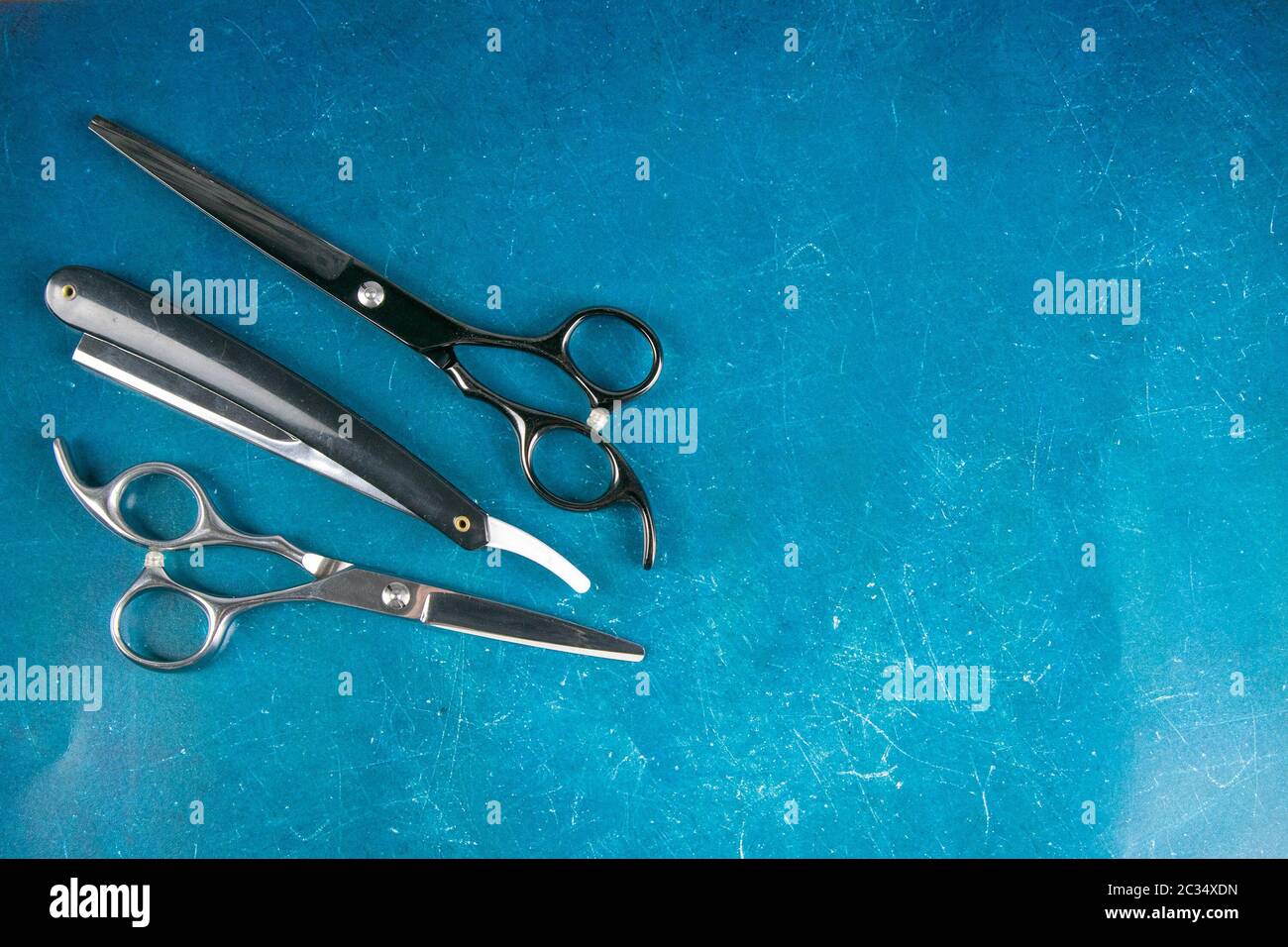 Scissors on blue background. Barber shop concept Stock Photo - Alamy