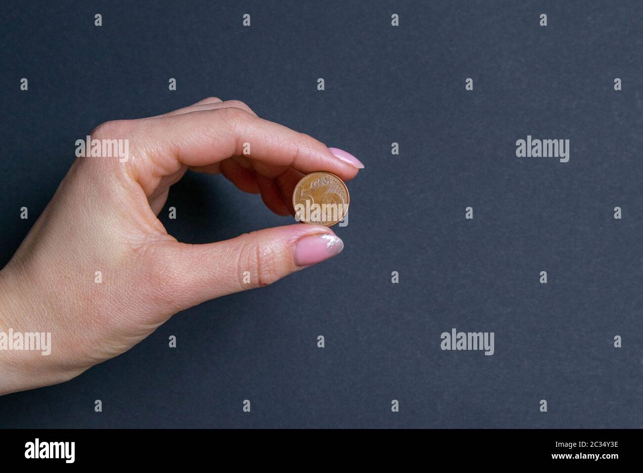 Hand sign by holding a coin, isolated on black background Stock Photo ...
