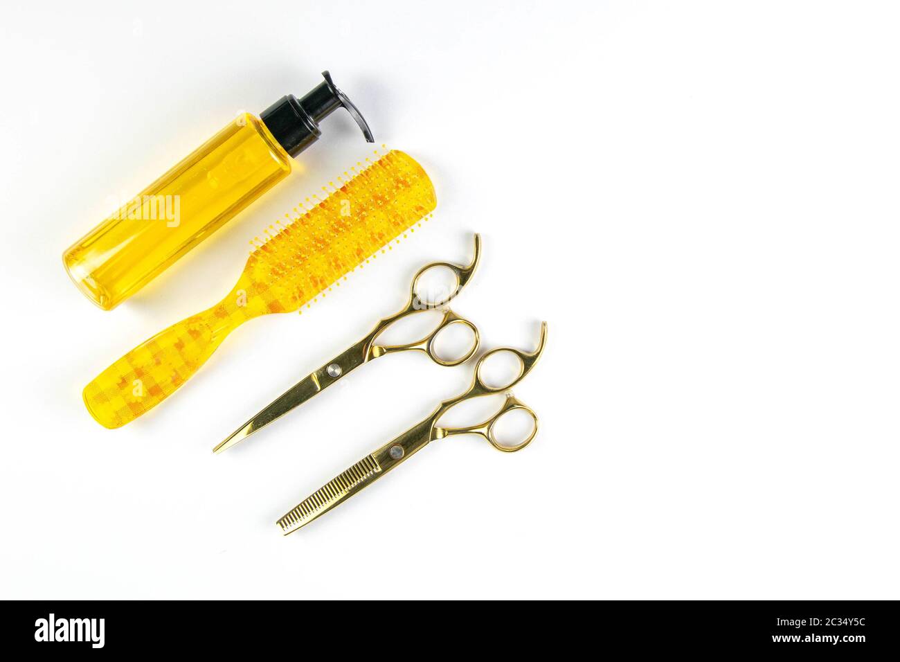 Hair gel, comb and scissors for haircut stand on a white towel which ...