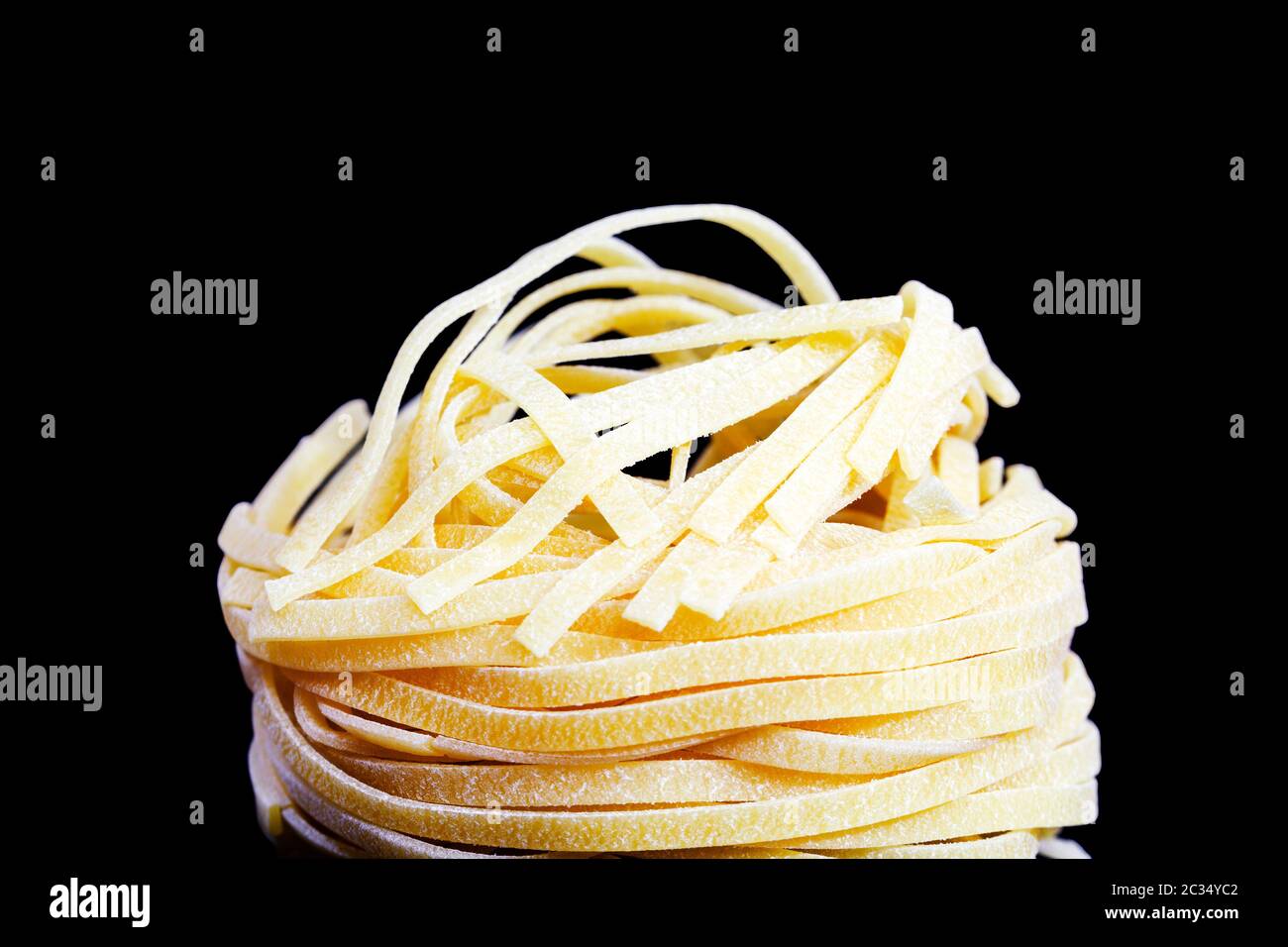 home cooked real pasta on a black background, not cooked in a raw form ...