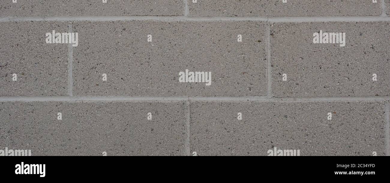 wide grey concrete brick wall useful as a background Stock Photo - Alamy