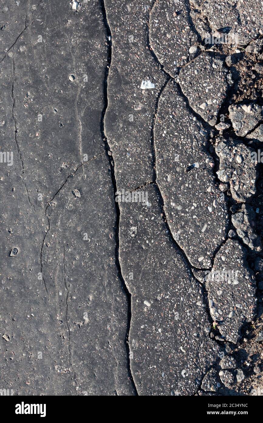 old damaged asphalt road with permanent damage and poor quality, poor ...