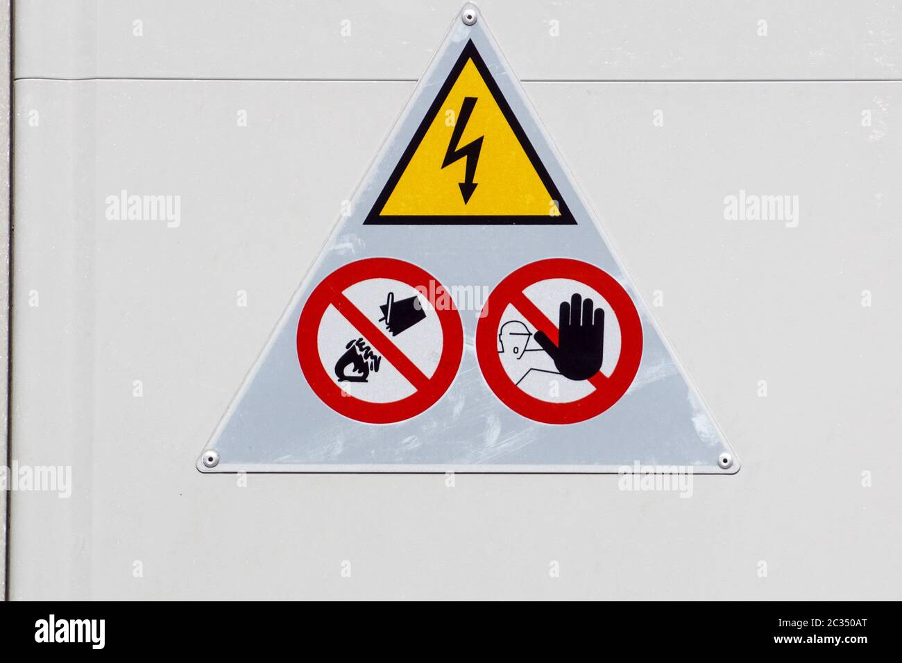 Danger hard hat area safety warning sign on a chain link fence at a ...