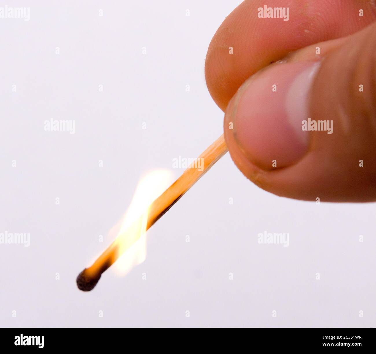 Hand holding a burning match Stock Photo - Alamy