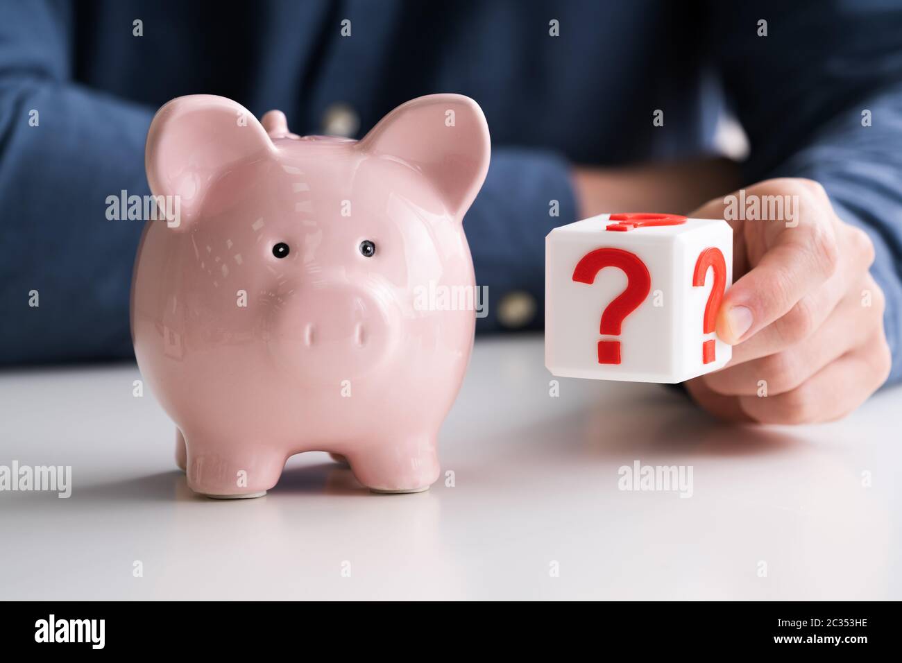 Man Holding Question Mark Next To Piggy Bank. Money Saving And ...