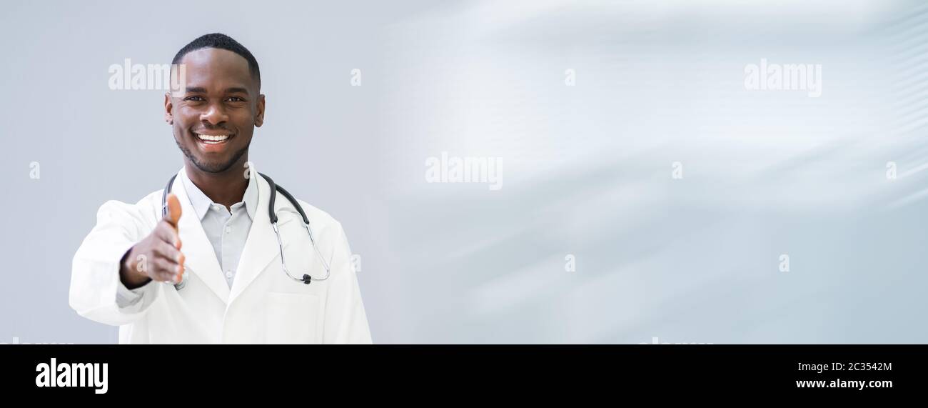 Portrait Of Happy Confident Doctor Offering Handshake In Hospital ...
