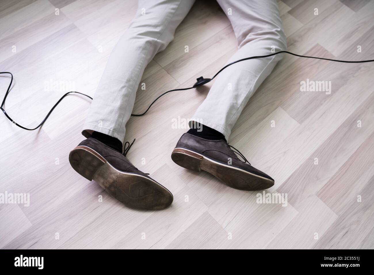 An Elevated View Of Man Stumbling With An Electrical Cord Stock Photo ...