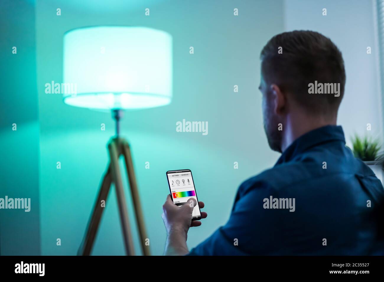 Smart home man controlling lights hi-res stock photography and images ...