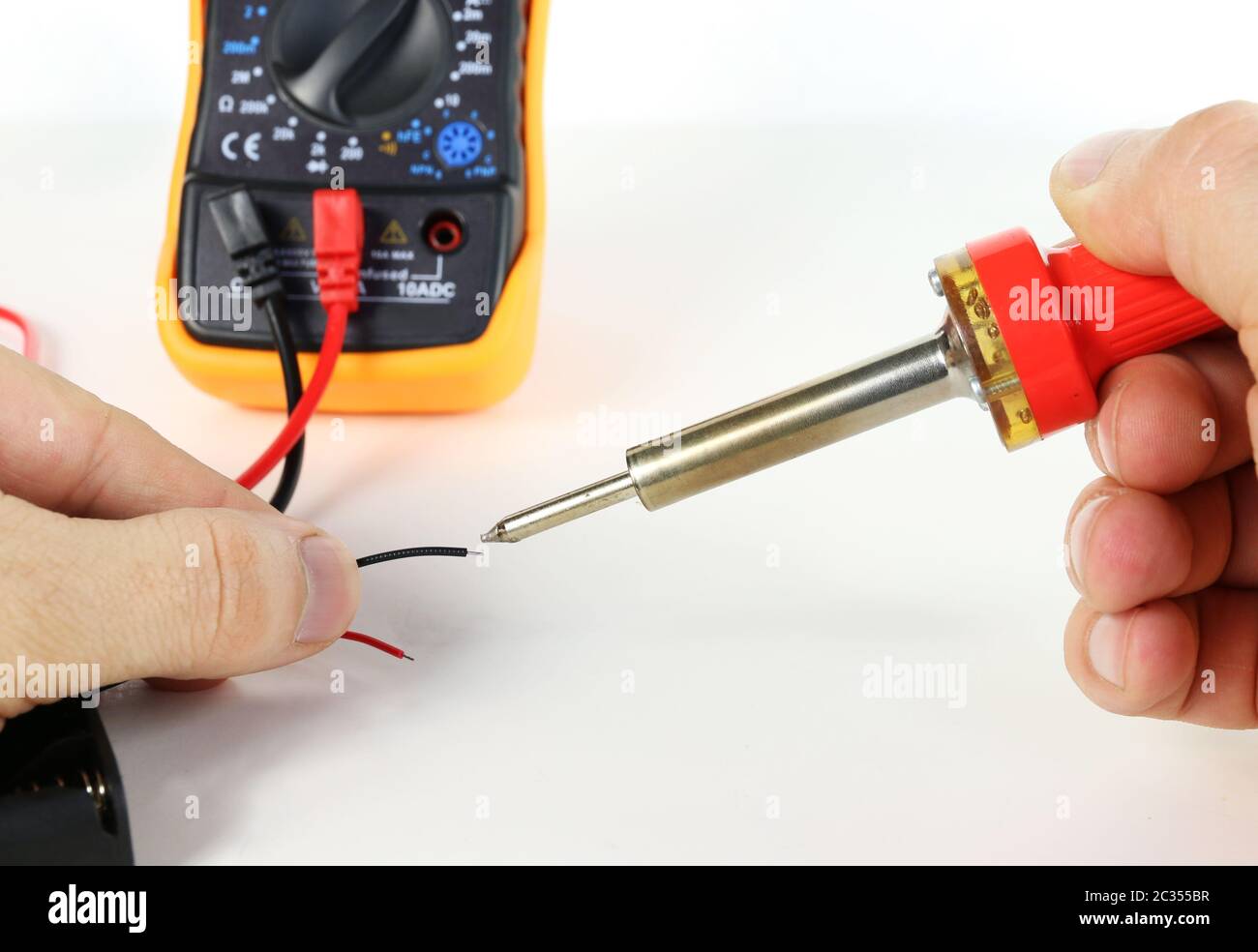 Man soldering wire with soldering iron Stock Photo - Alamy