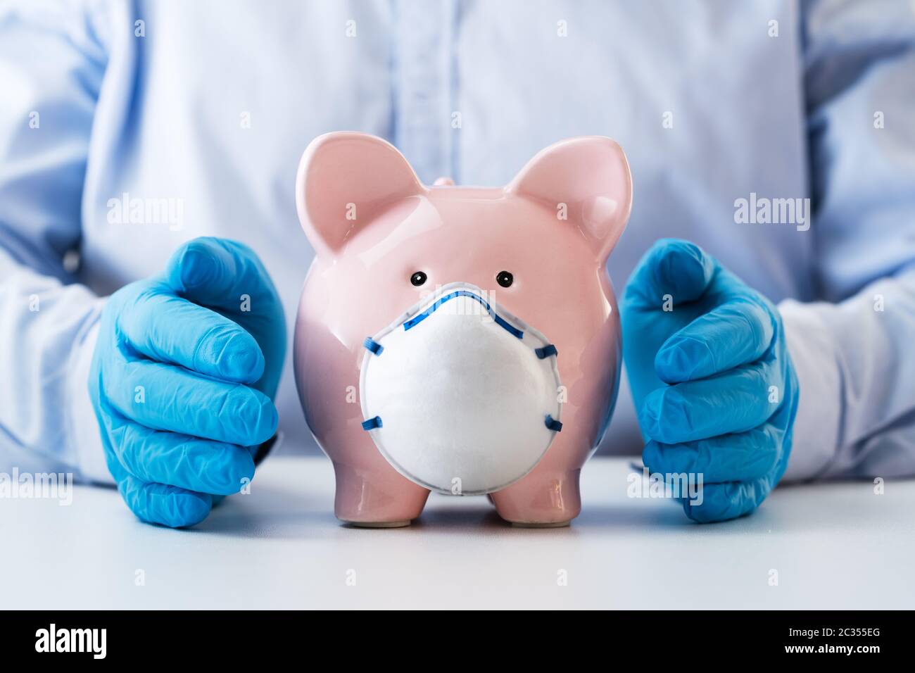 Close-up Of A Human Hand Protecting Pink Piggy Bank On White Desk Stock ...