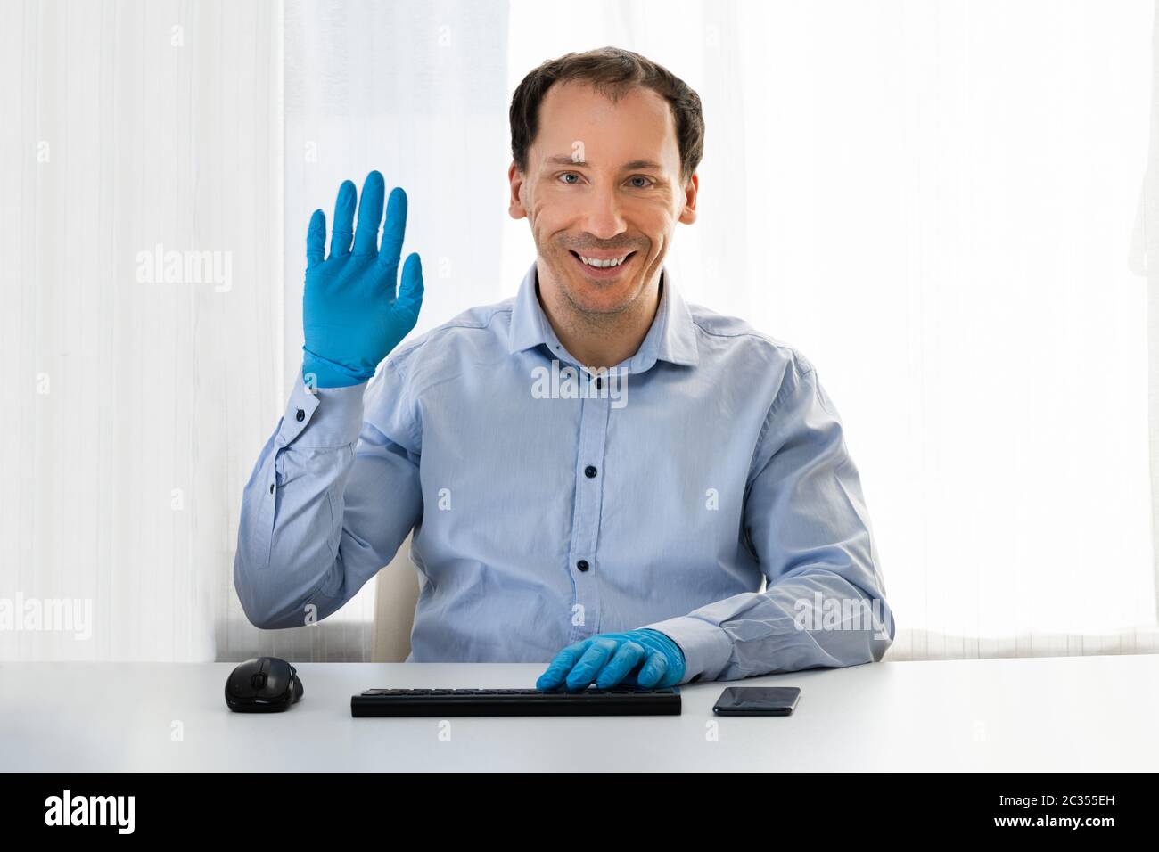 Portrait Of A Happy Young Man Waving His Hand Stock Photo - Alamy
