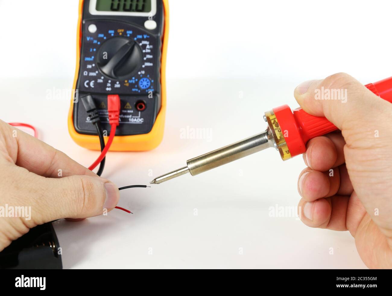 Man soldering wire with soldering iron Stock Photo - Alamy