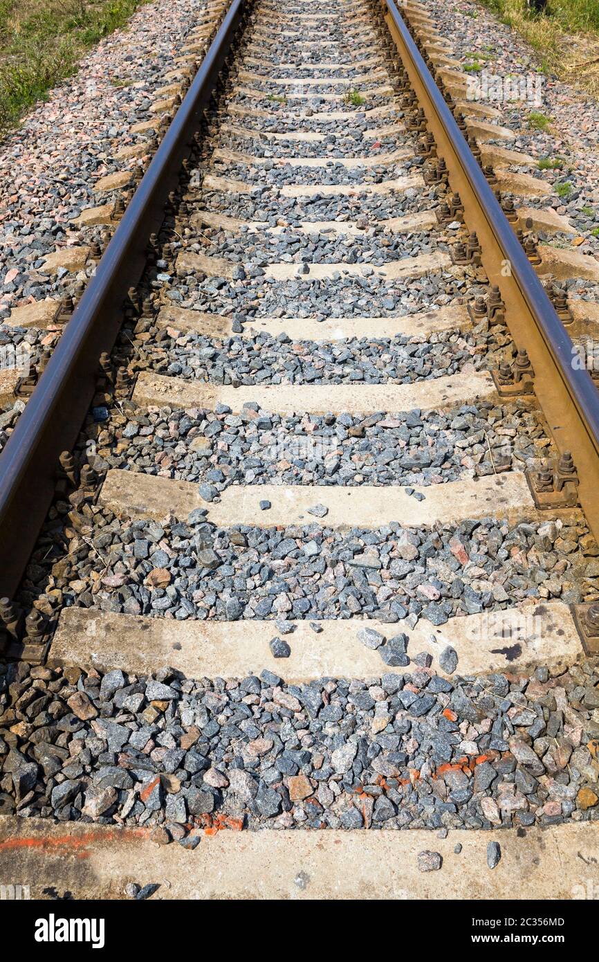 an old railroad with rusty worn rails and concrete sleepers Stock Photo ...