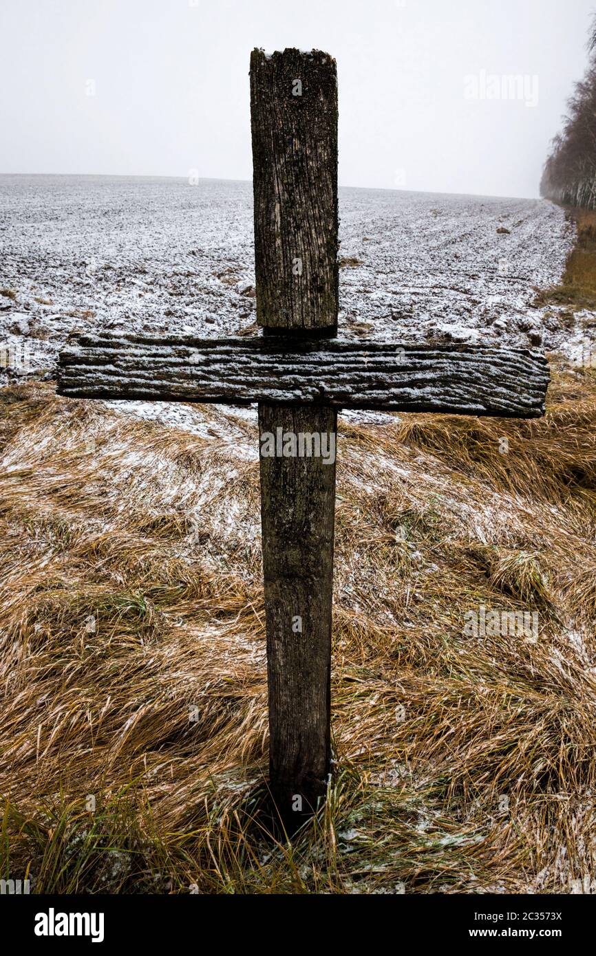 old wooden Catholic cross against blue sky and white clouds in Sunny ...
