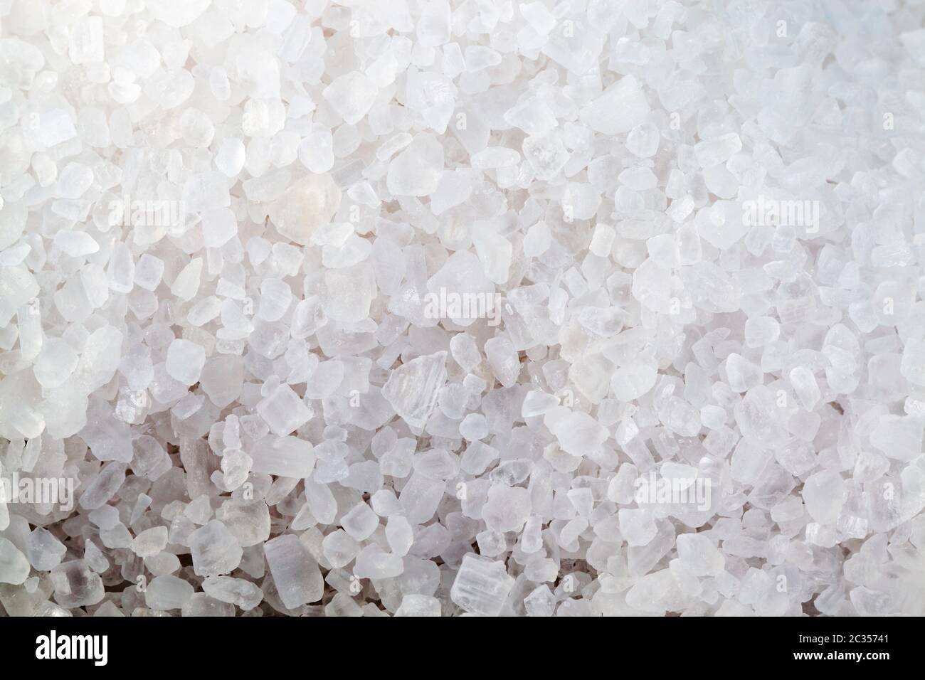 large coarse salt on the Board, spices used in cooking, close up and ...