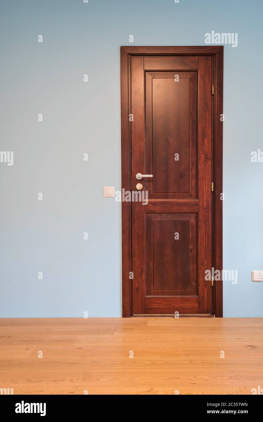 Frontal view to the wooden door in home interior room with wooden ...