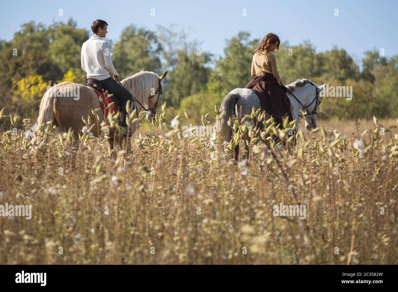 Young couple in love riding a horse Stock Photo - Alamy